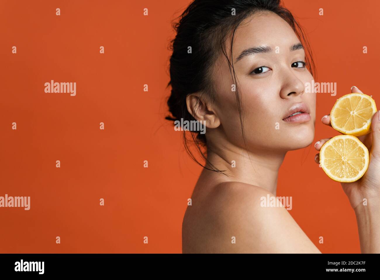 Beauty portrait of a beautiful opless young asian woman posing while ...