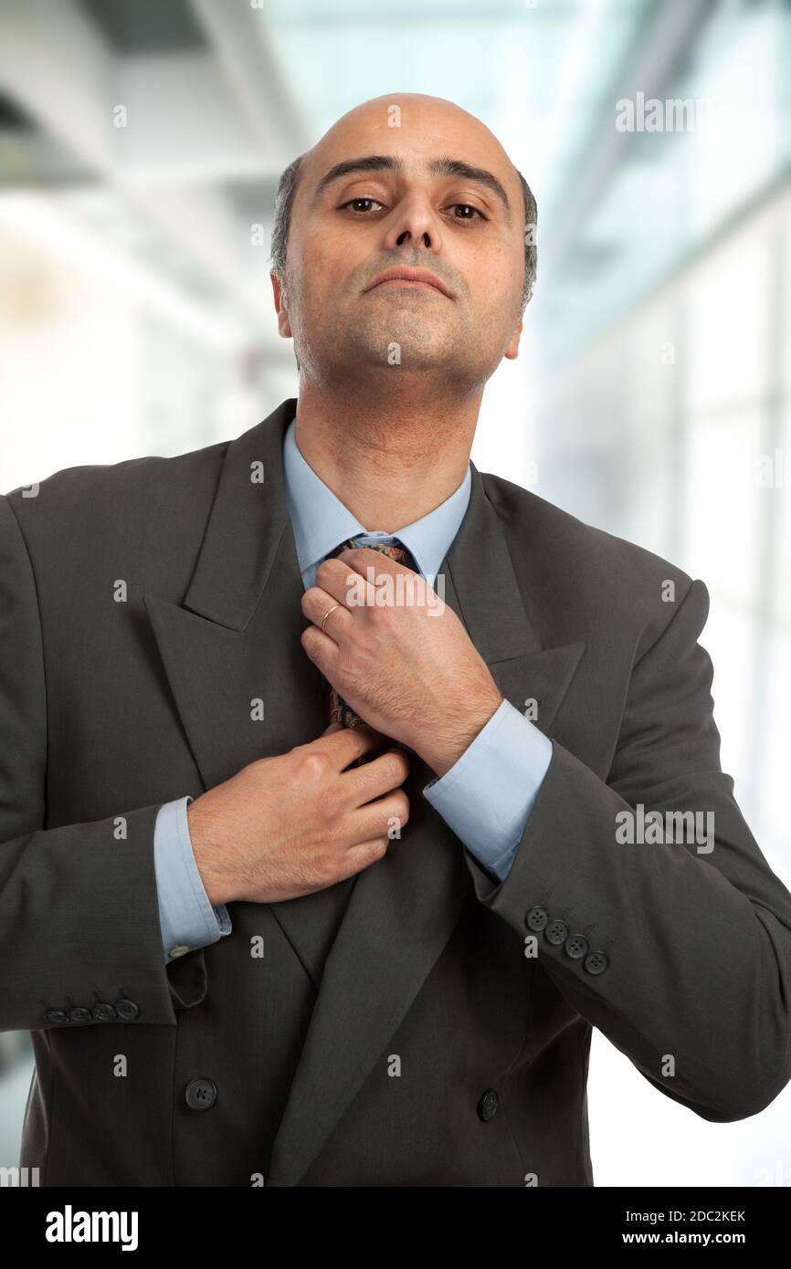 mature business man adjusting his tie, close up Stock Photo - Alamy