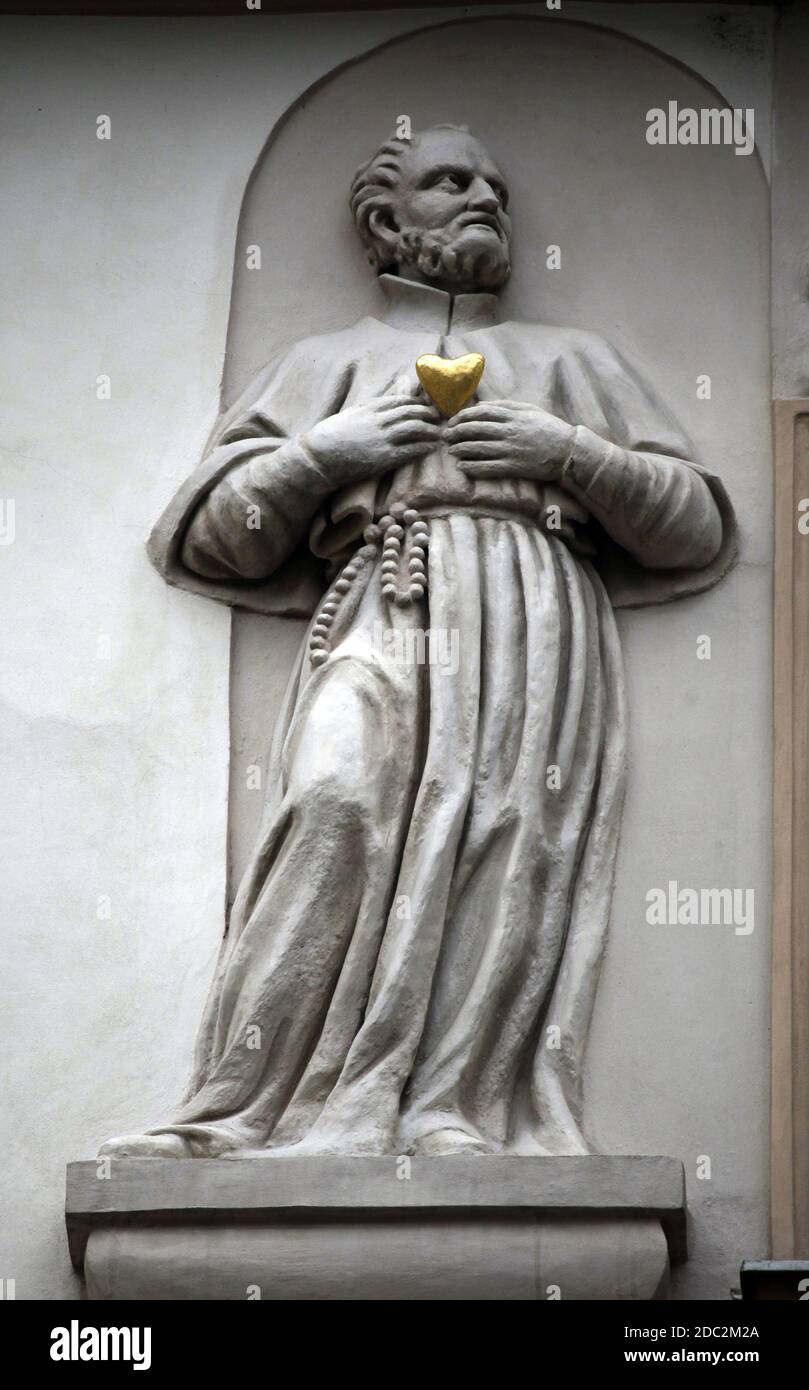 Saint on facade, House of the Golden Well, Prague Stock Photo - Alamy