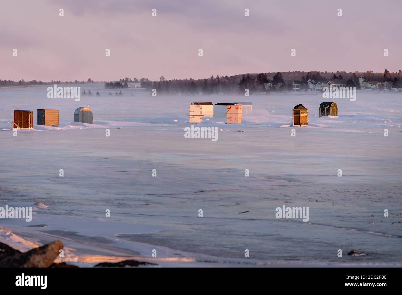 Ice fishing along the frozen shores of Prince Edward Island, Canada ...