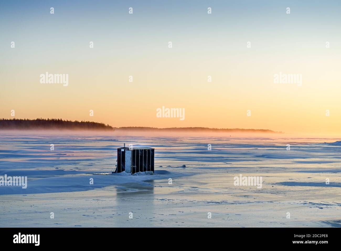 Ice fishing along the frozen shores of Prince Edward Island, Canada ...