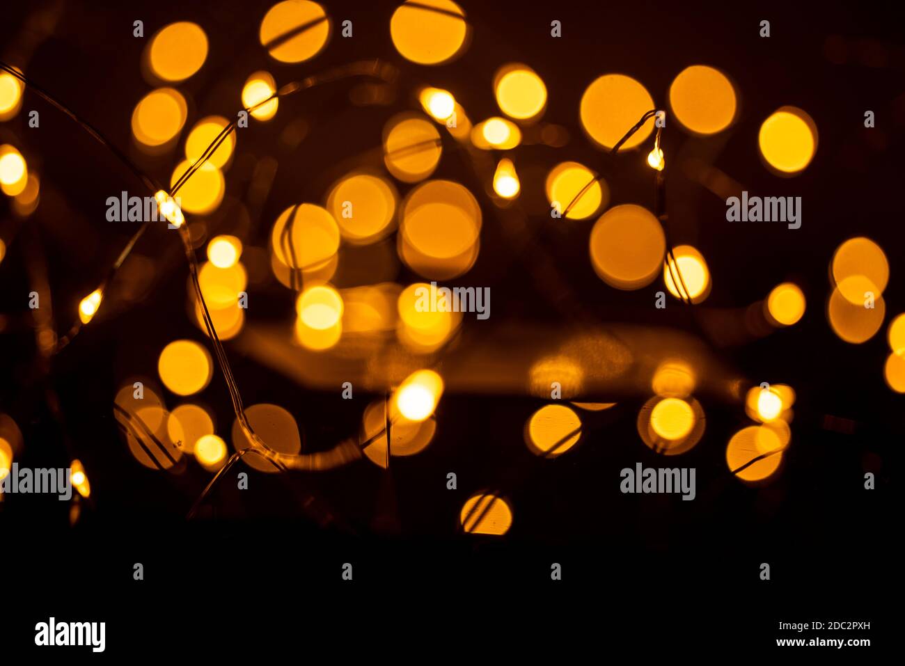 Yellow Christmas lights on black background. New Year celebration ...