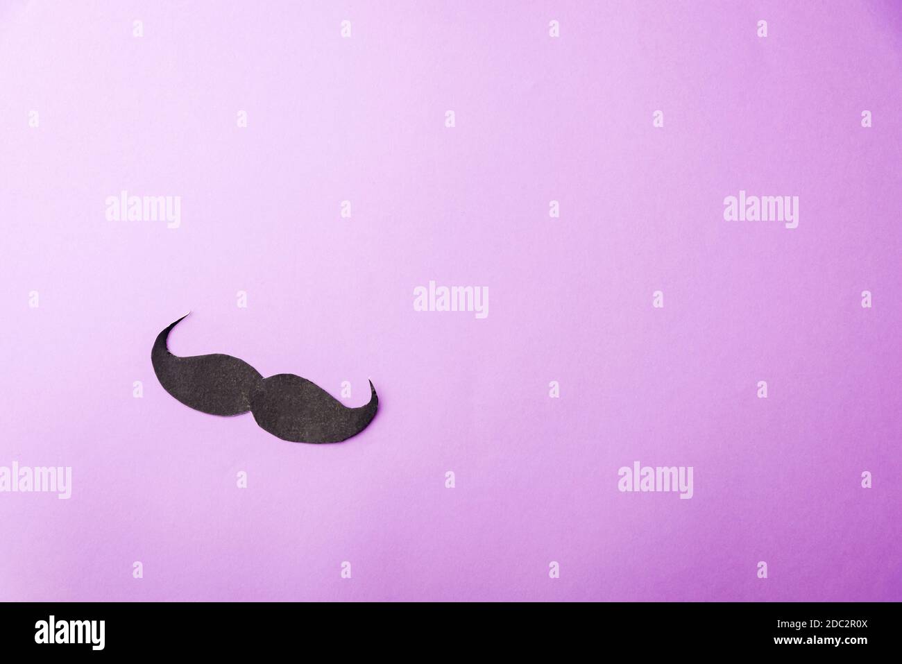 Black mustache paper, studio shot isolated on purple background ...