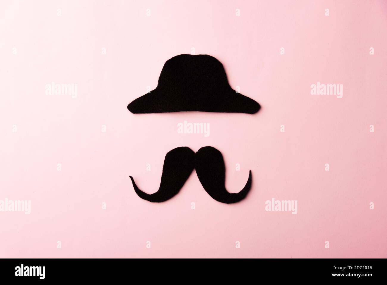 Black mustache and cap, studio shot isolated on pink background ...