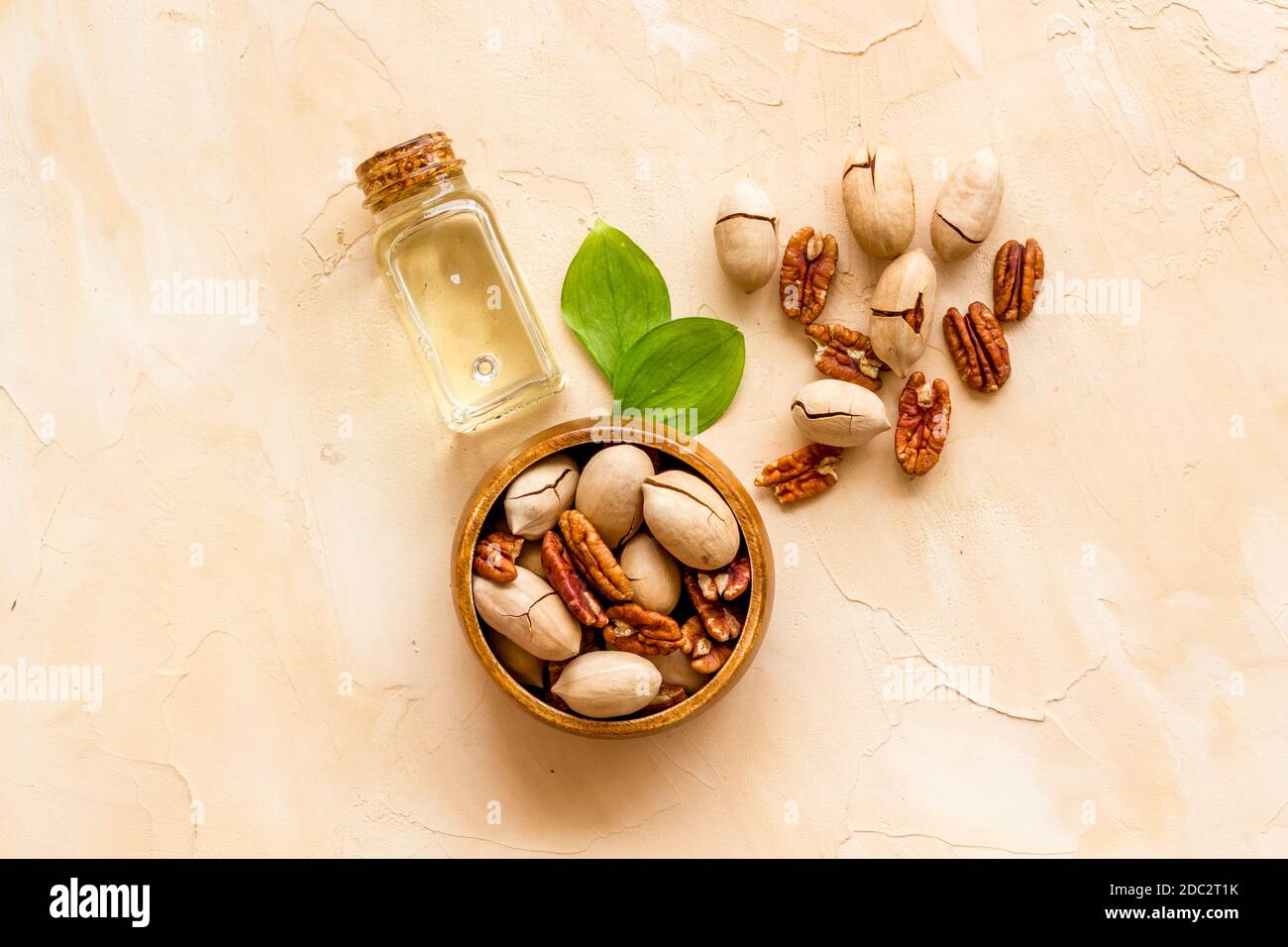 Pecan essential oil with raw nuts, top view Stock Photo - Alamy