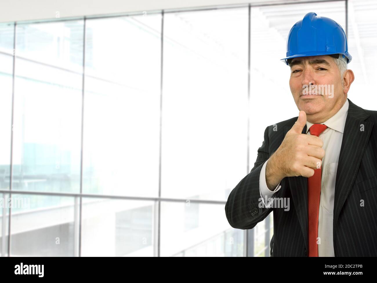 An engineer with blue hat at the office Stock Photo - Alamy