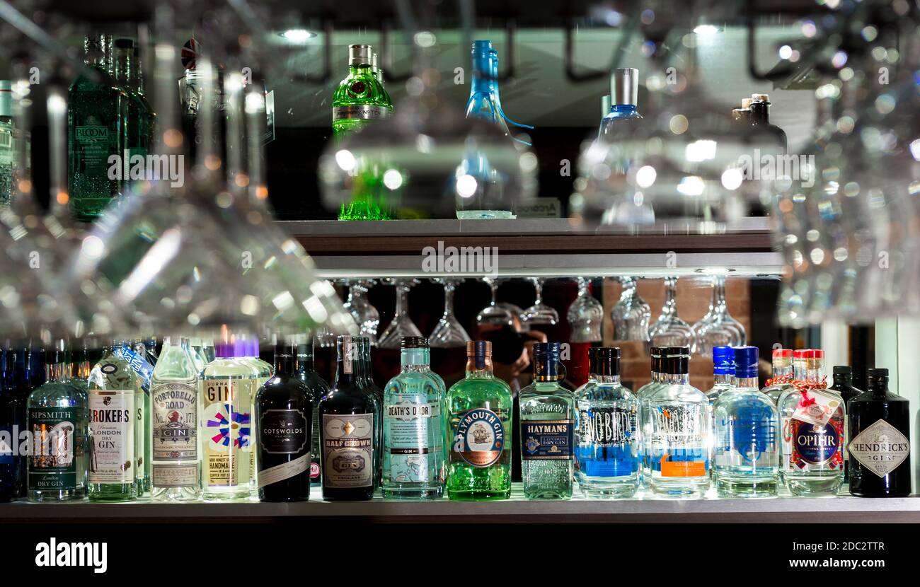 Bottles of gin lines up behind an empty bar, in a pub in England. UK ...