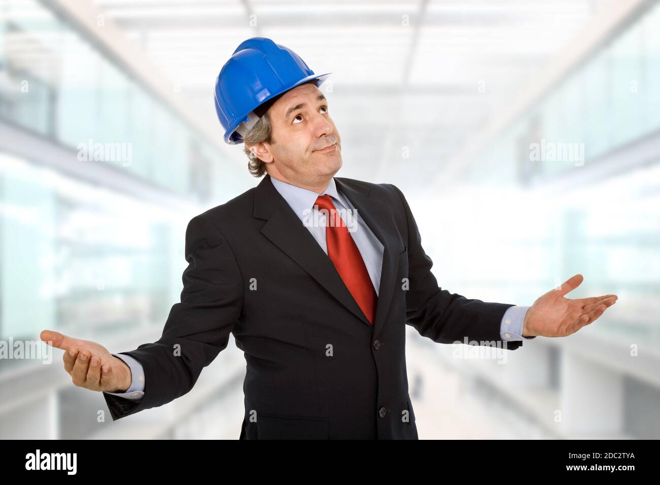 An engineer with blue hat asking at the office Stock Photo - Alamy