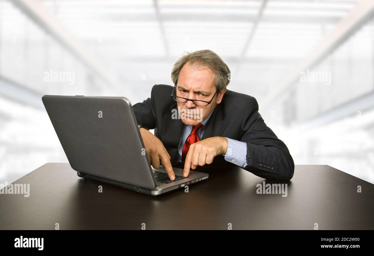 mature business man working with his laptop Stock Photo - Alamy
