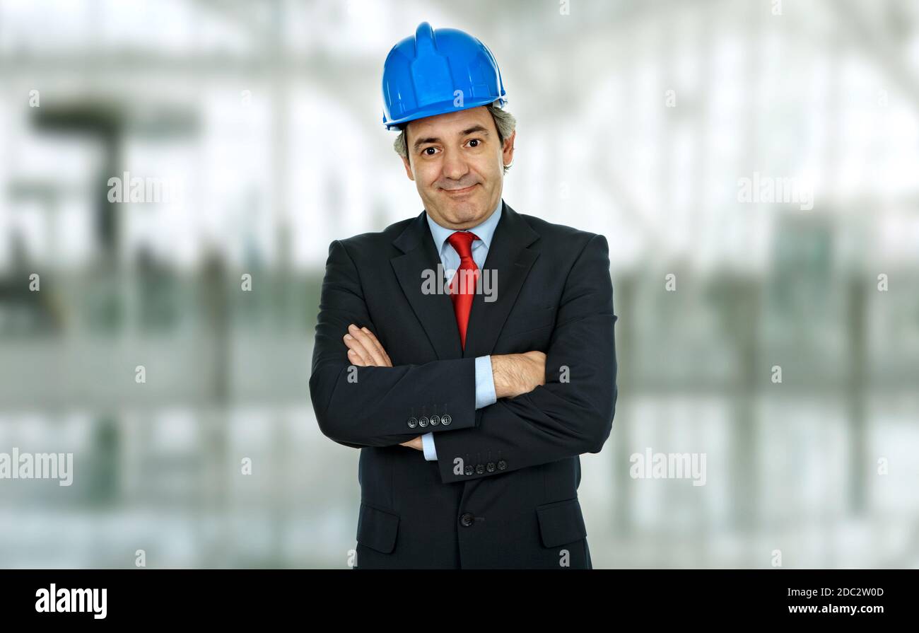 An engineer with blue hat at the office Stock Photo - Alamy