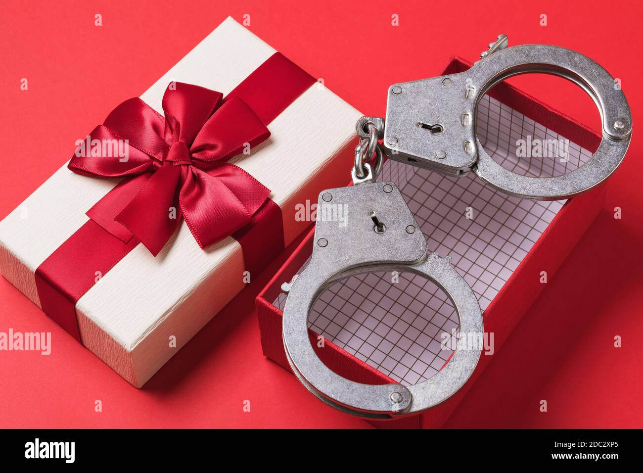 Handcuffs and an open gift box. Concept on the topic of corruption ...
