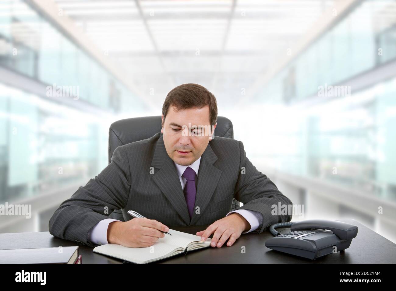 executive at work on his desk at the office Stock Photo - Alamy