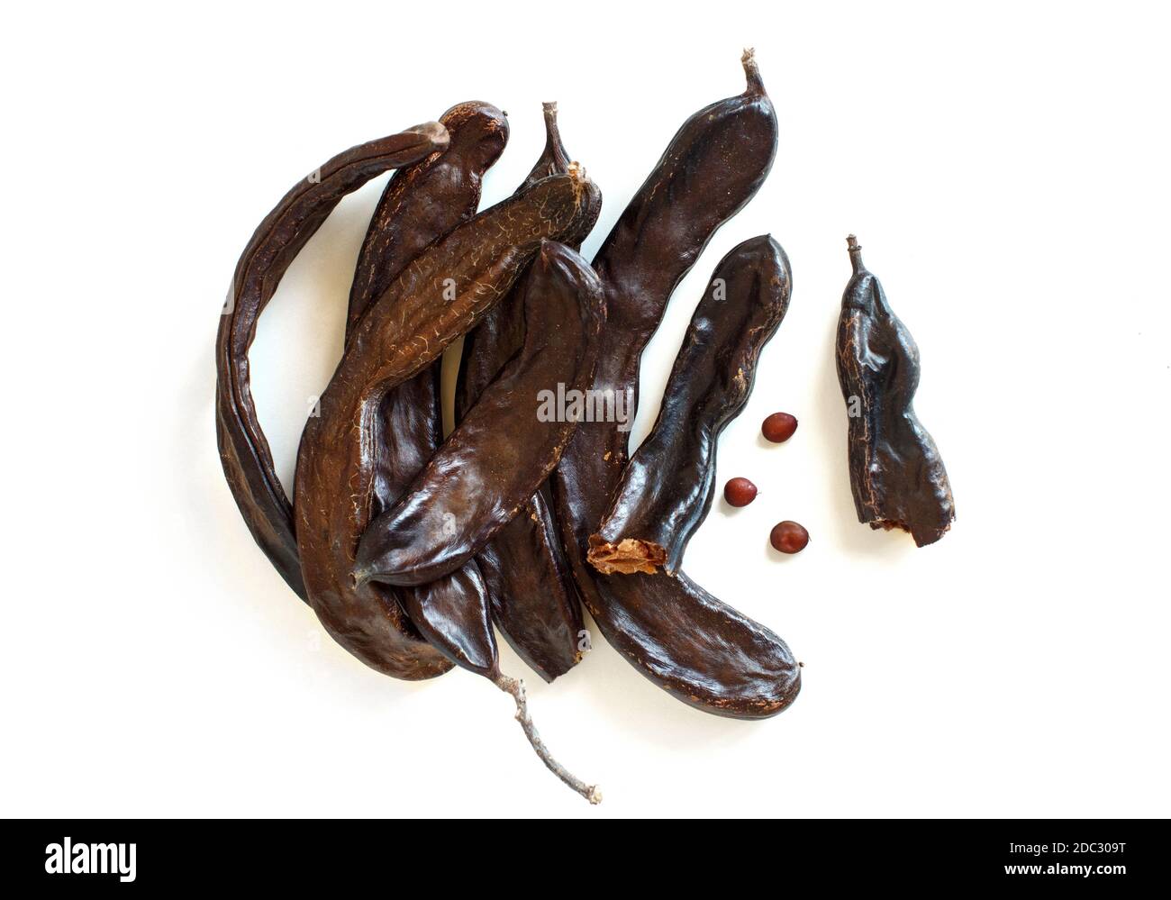 Dry carob pods and seeds top view Stock Photo - Alamy