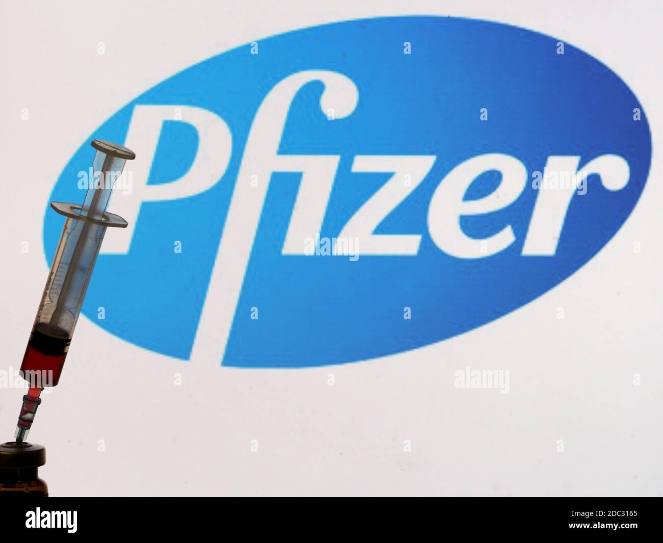 In this photoillustratn medical syringe is seen with Pfizer company ...