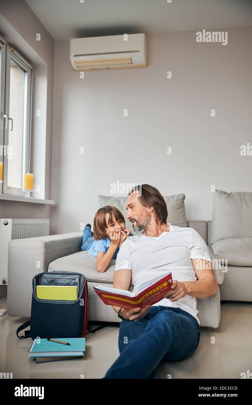 Curious child and his helpful dad studying at home Stock Photo - Alamy