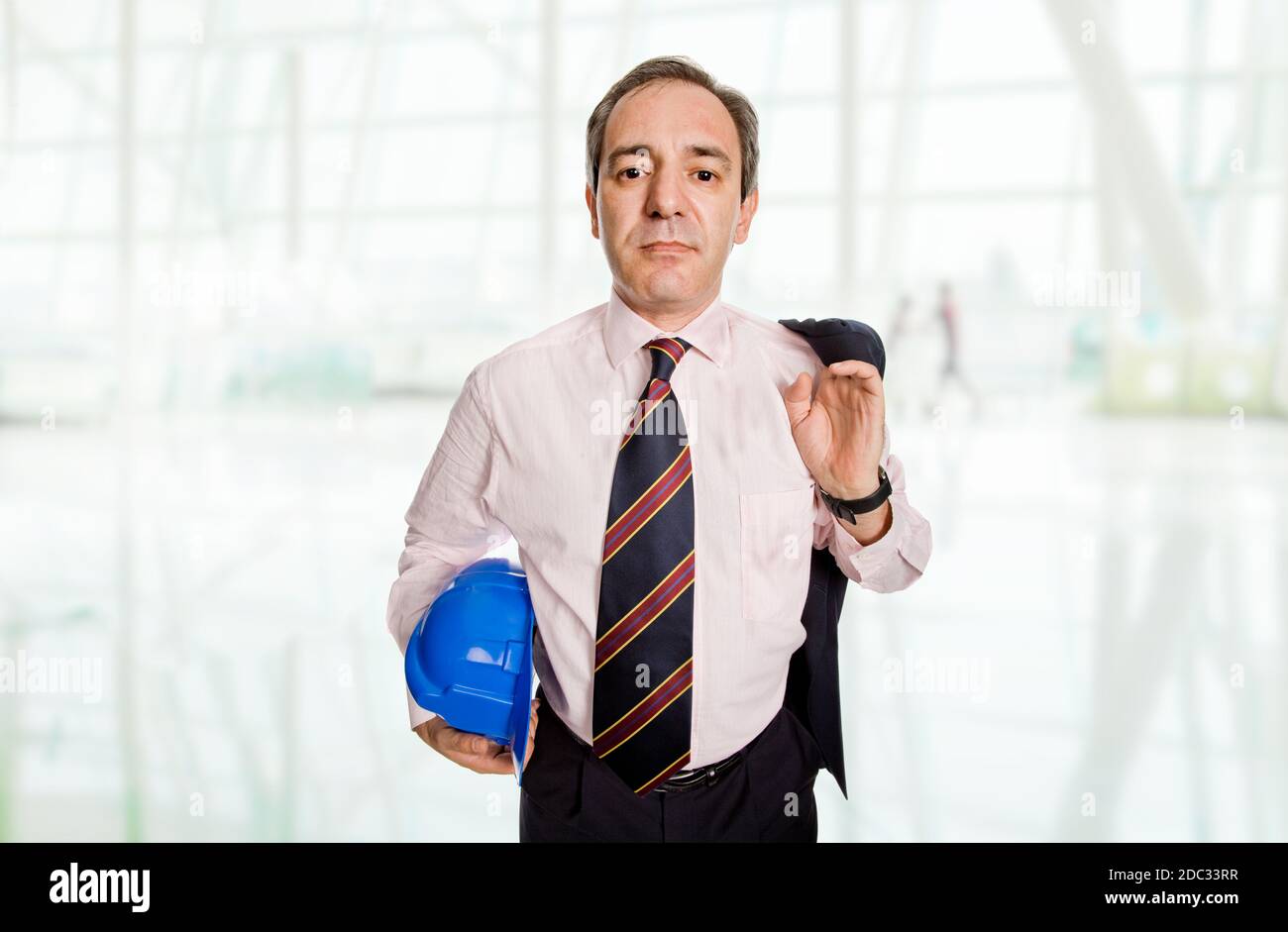 An engineer with blue hat at the office Stock Photo - Alamy
