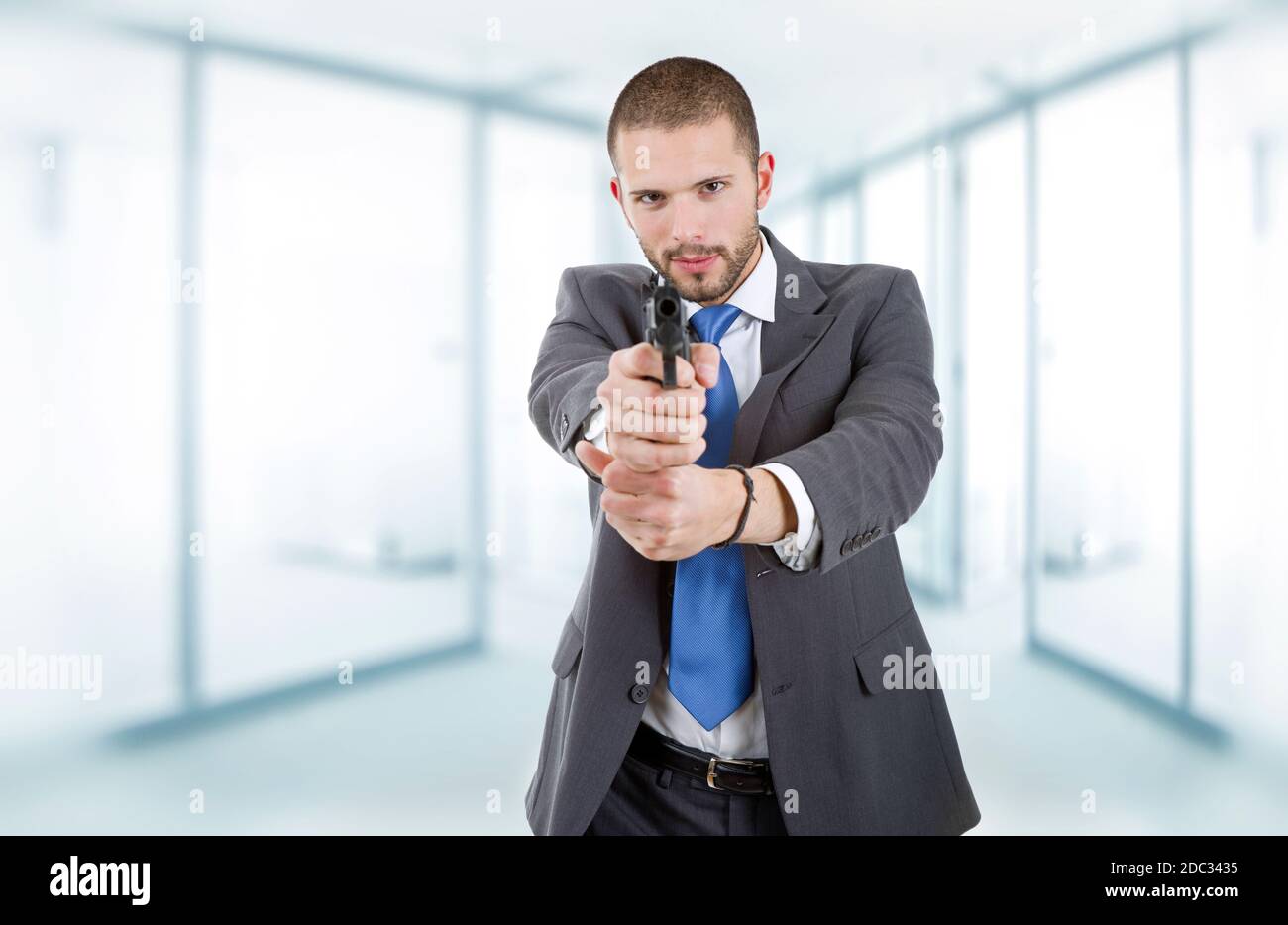 Young businessman gun office hi-res stock photography and images - Alamy