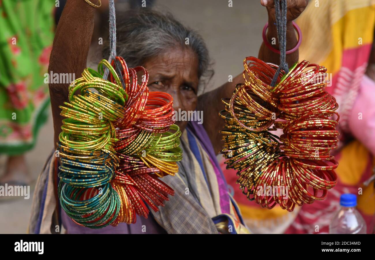 Guwahati, Assam, India. 18th Nov, 2020. A aged woman sells glass ...
