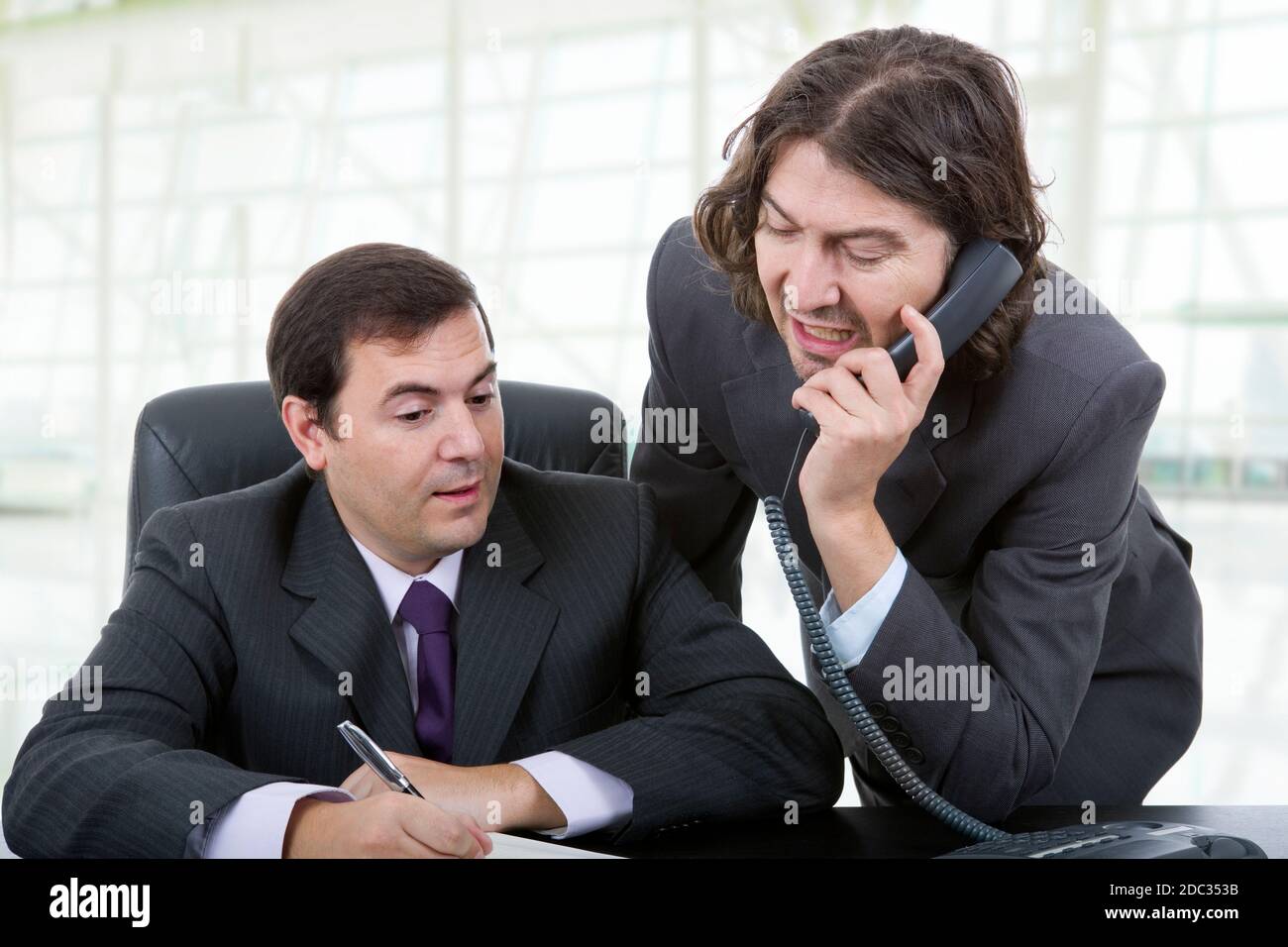 business team working at a desk, at the office Stock Photo - Alamy