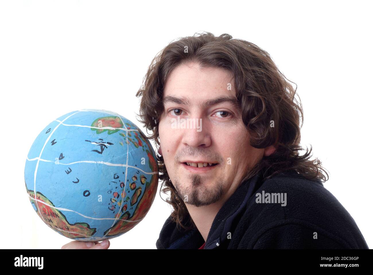 young man with globe isolated in white background Stock Photo - Alamy