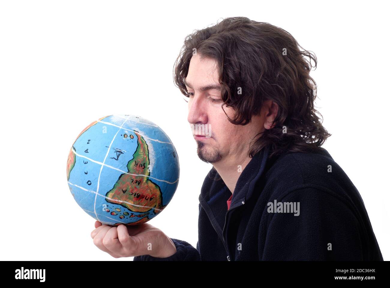 young man with globe isolated in white background Stock Photo - Alamy