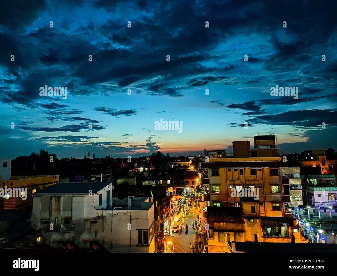 Picture of evening view of a city with a street along with street light ...