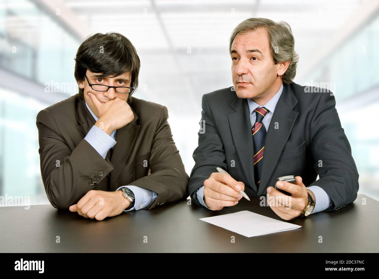 business team working at a desk at the office Stock Photo - Alamy