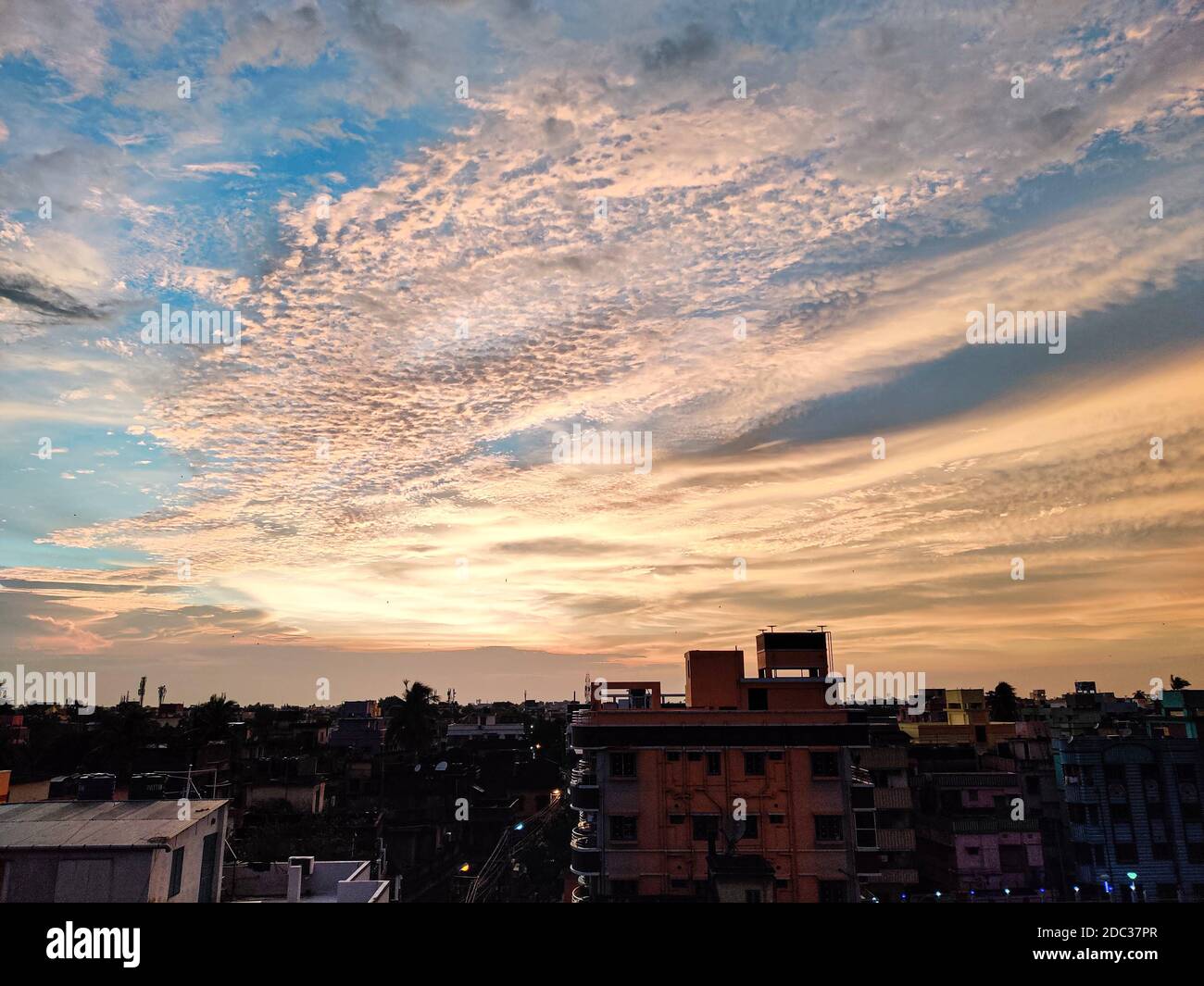 picture of evening sunset with the houses in background and clouds in ...