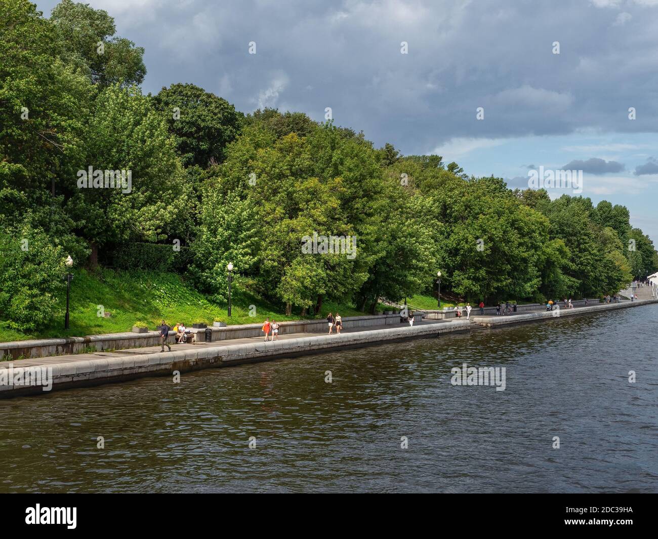 The embankment of the Moscow river. A shady green embankment along a ...