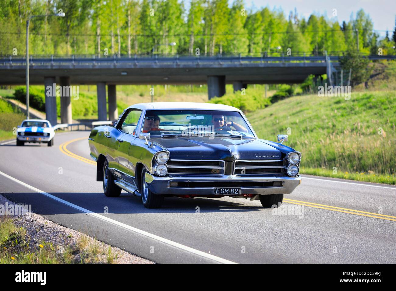 Black Pontiac Bonneville 4-Door Hardtop, mid-1960s, and people enjoying ...
