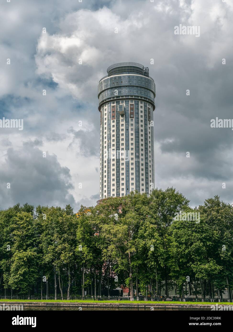 Modern round high-rise building on a green hill. Khimki District ...