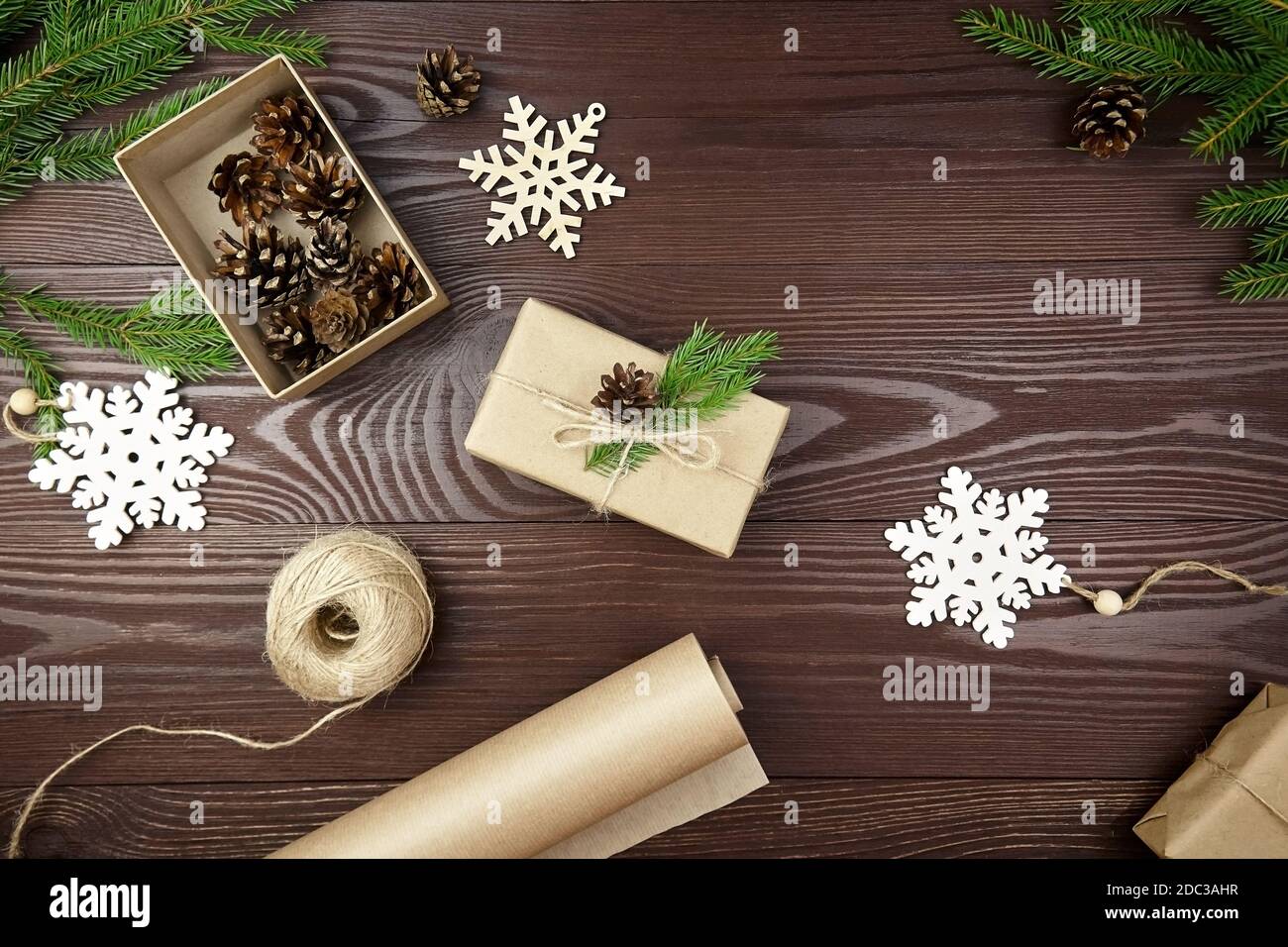 Composition for decorating Christmas gift boxes over dark wooden table ...