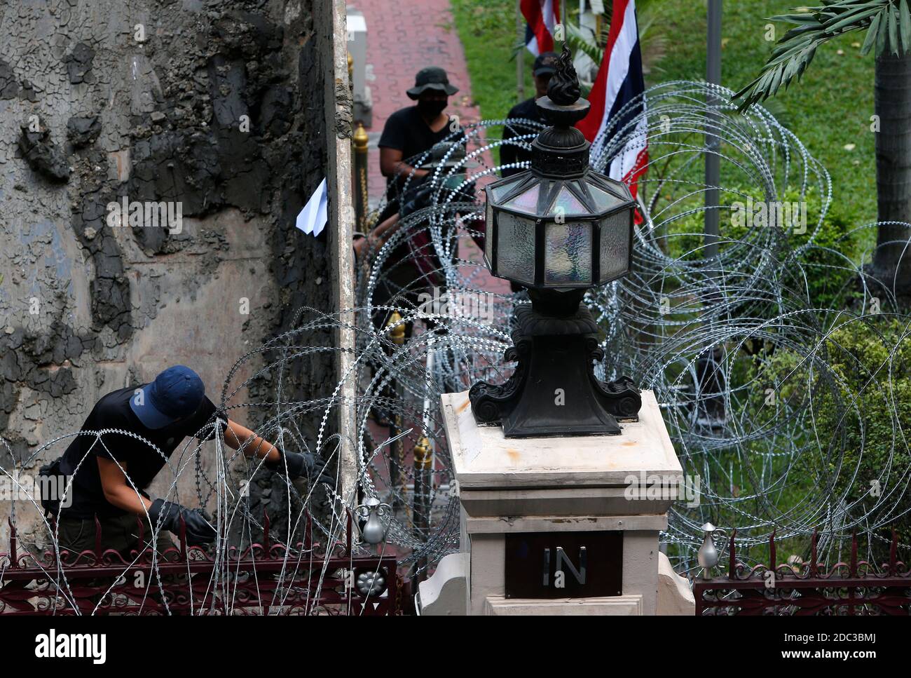 Police officers install barbed wire at a fence of the Royal Thai Police ...