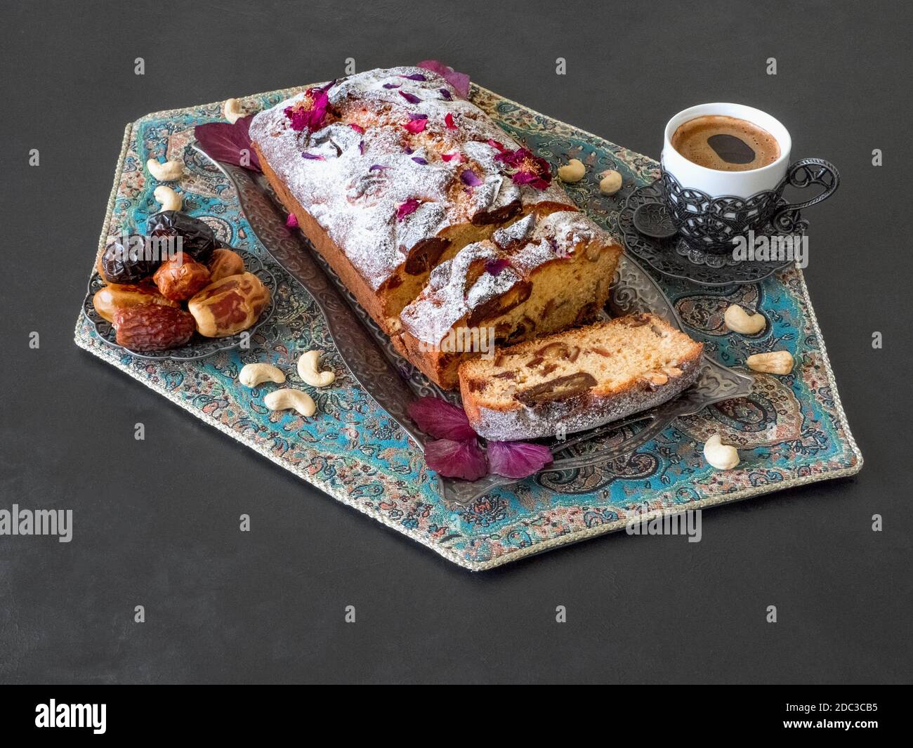Homemade Ramadan date and walnut cake on black table Stock Photo - Alamy