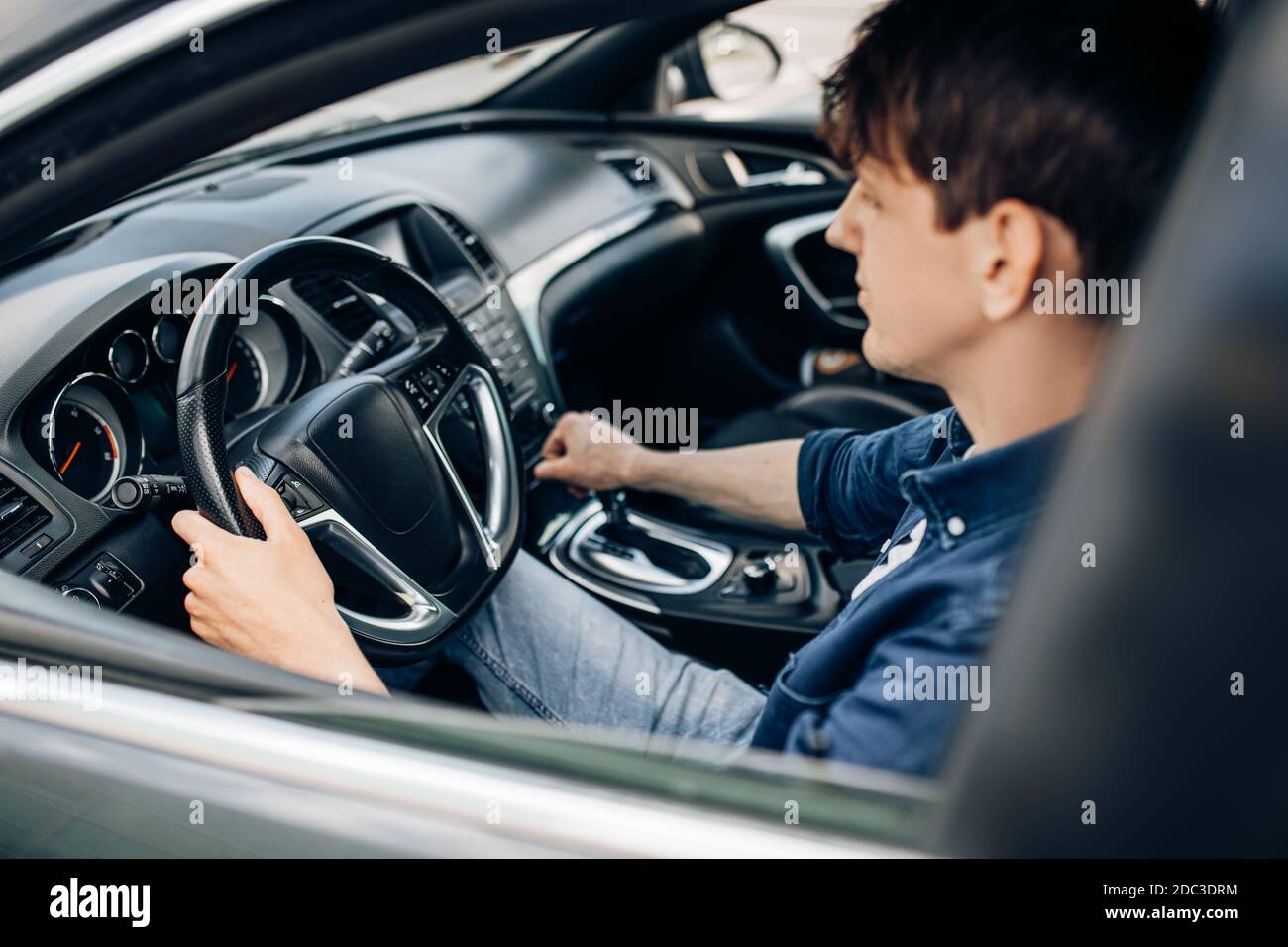 A young man who buys a car while sitting in the driver's seat is ...