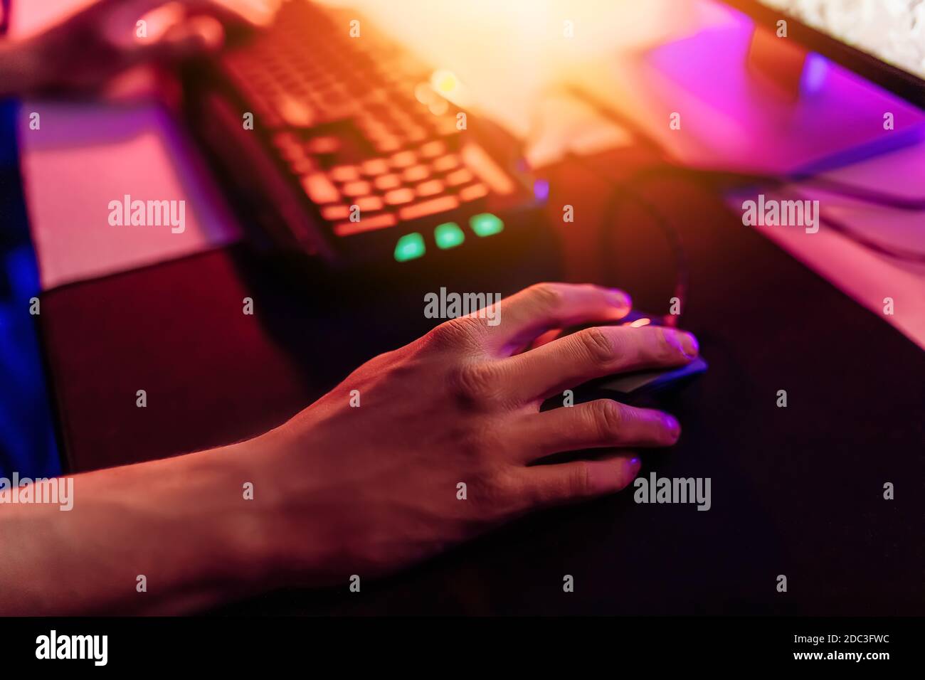 Close-up of a gamer's hand on a computer mouse, a person playing video ...