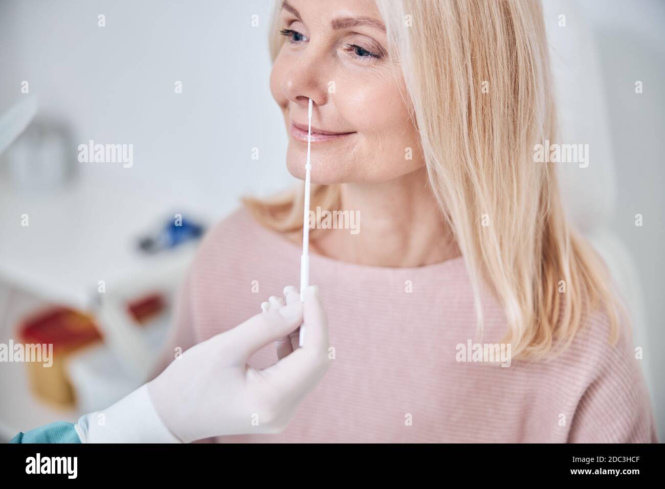 Smiling female patient undergoing a medical procedure Stock Photo - Alamy