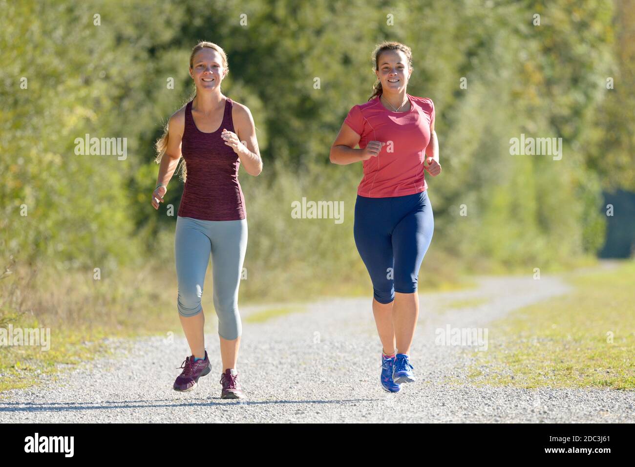 Young friends jogging together hi-res stock photography and images - Alamy
