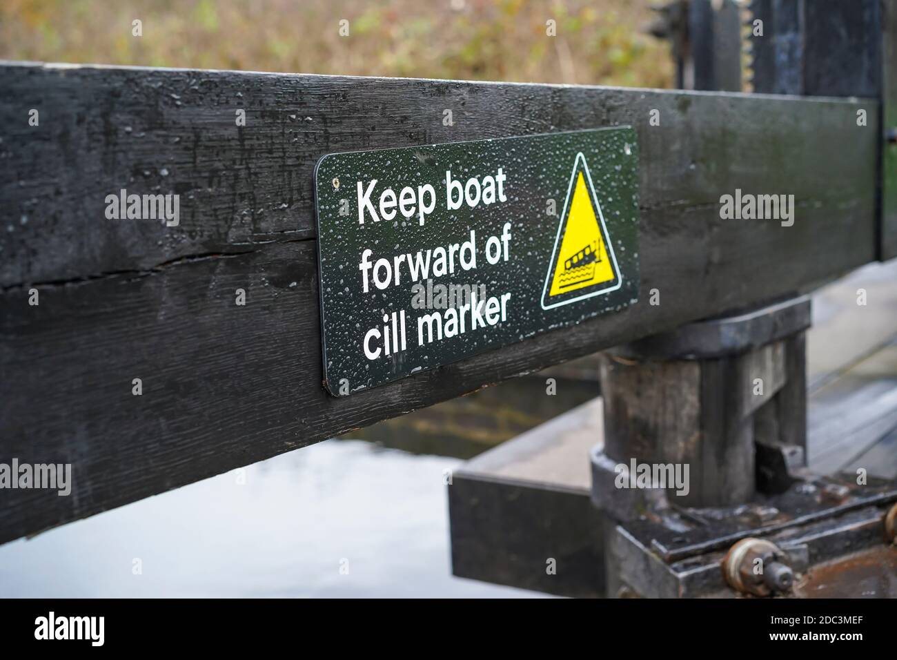 Warning sign 'Keep boat forward of cill marker' on a UK canal lock gate ...