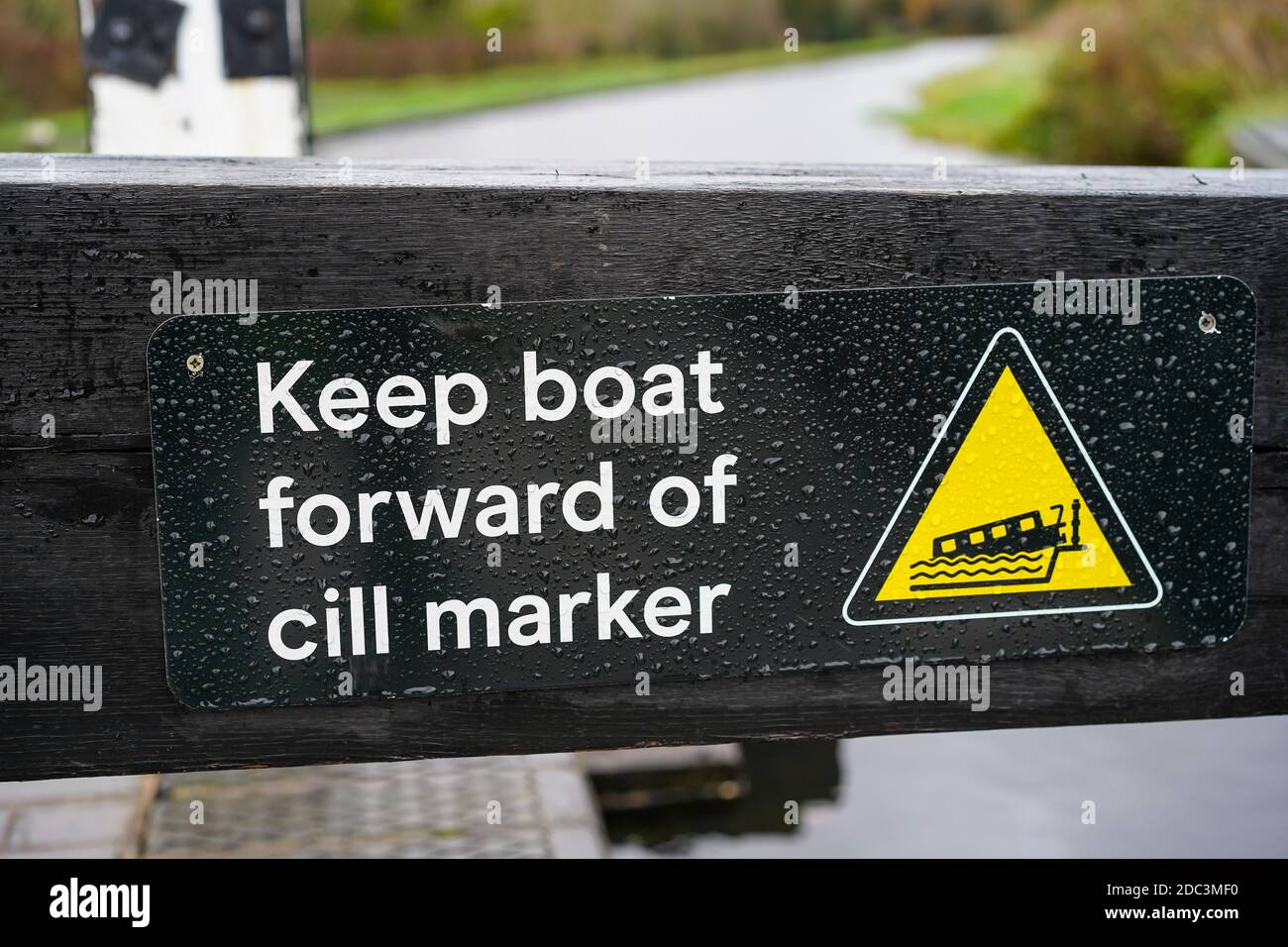 Warning sign 'Keep boat forward of cill marker' on a UK canal lock gate ...