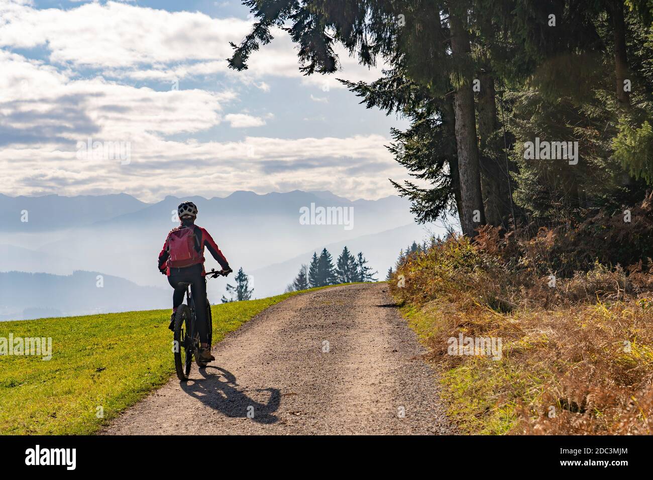 pretty senior woman riding her electric mountain bike in the mountains ...