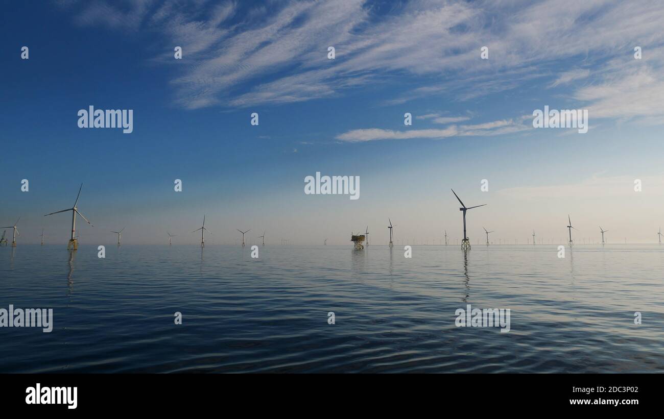 Wind turbines in German offshore wind farm at perfect weather and calm ...