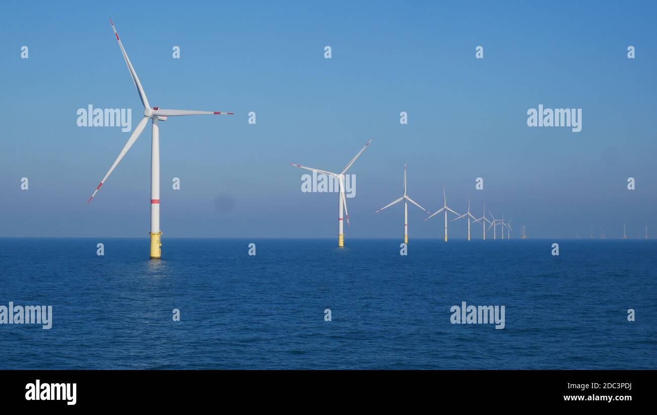German wind turbines in offshore wind farm in north sea during perfect ...