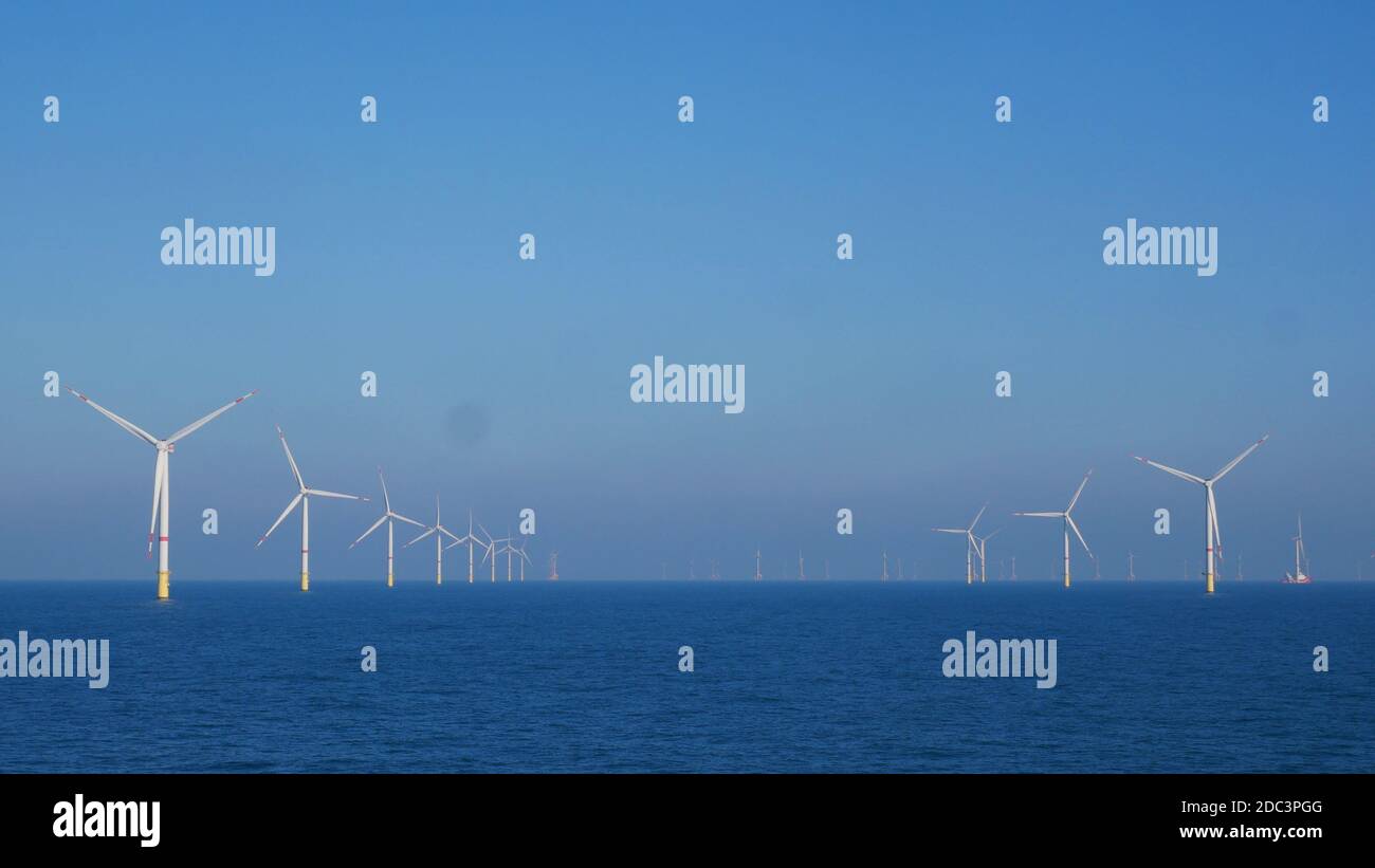 German wind turbines in offshore wind farm in north sea during perfect ...