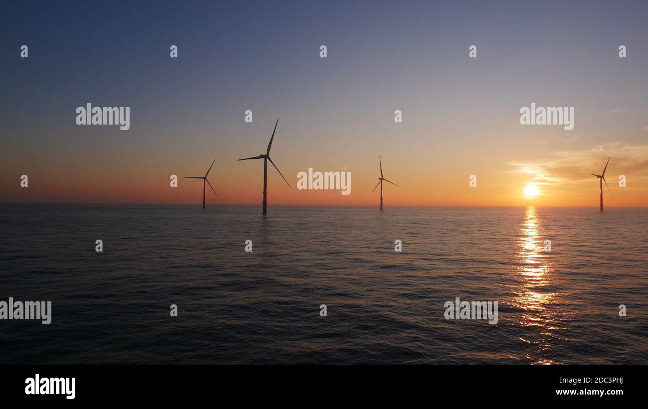 Dramatic sunset in offshore wind farm in north sea during perfect ...