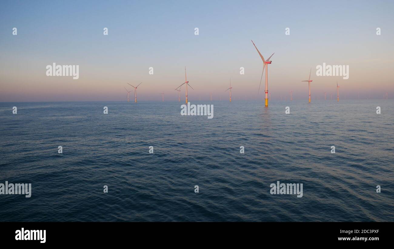 German wind turbines in offshore wind farm in north sea during perfect ...