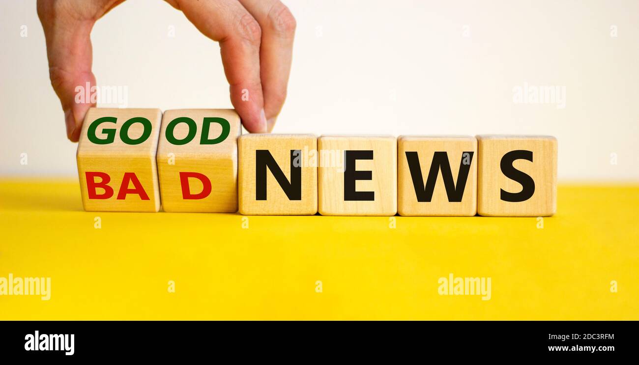 Good or bad news concept. Hand flips cubes and changes the words 'bad ...