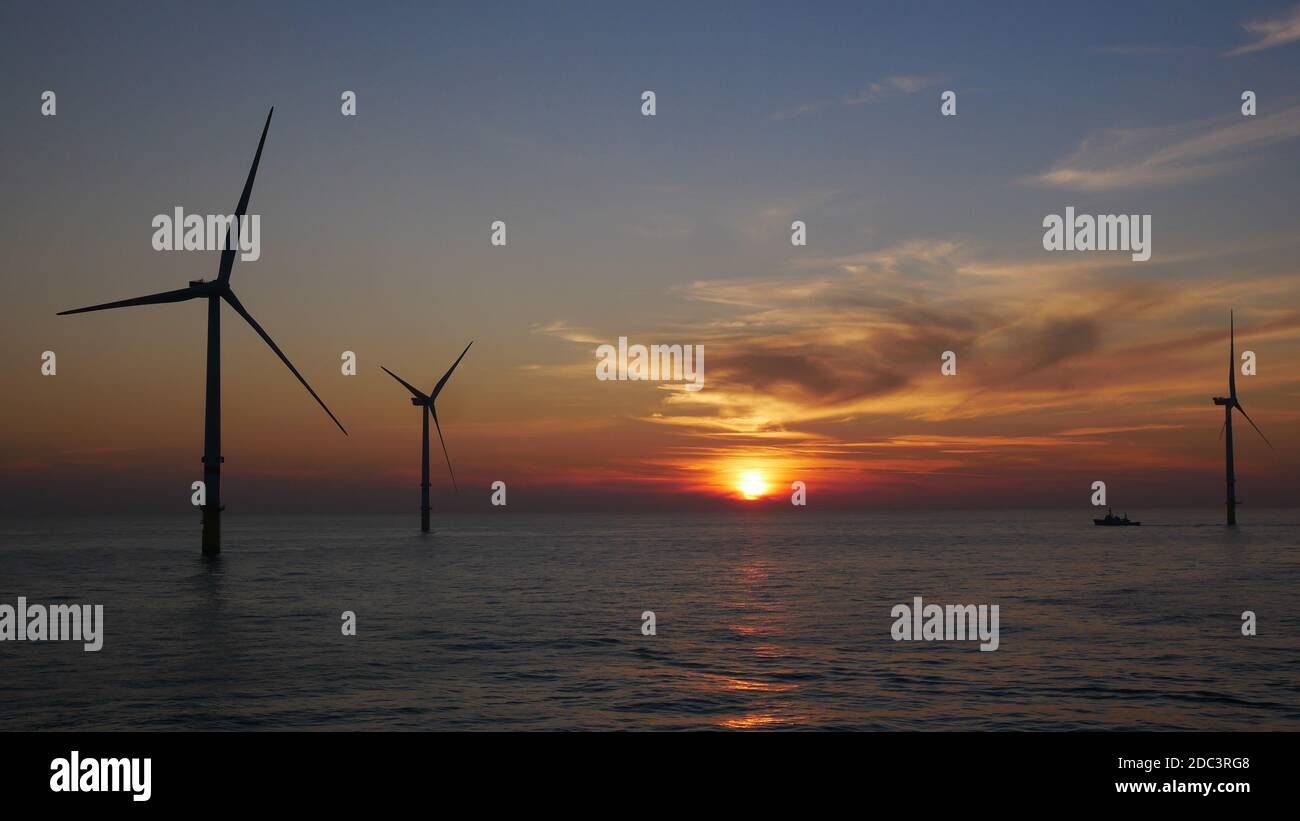 Dramatic sunset in offshore wind farm in north sea during perfect ...