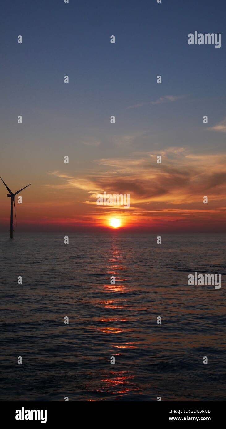 Dramatic sunset in offshore wind farm in north sea during perfect ...