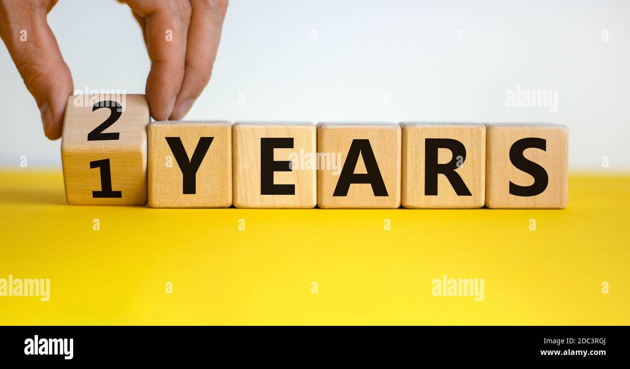 Male hand turns cubes and changes the expression '1 year' to '2 years ...